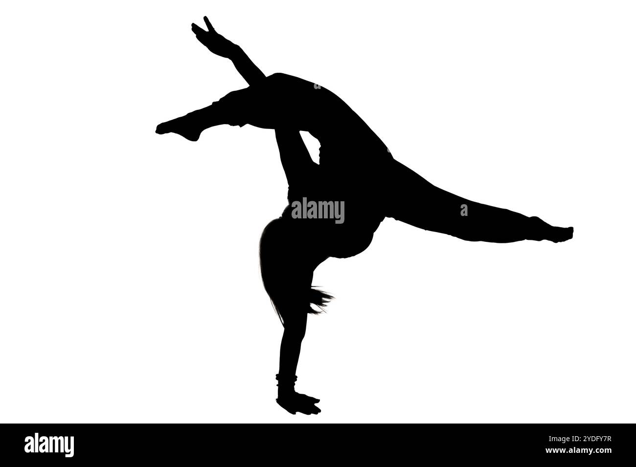 A silhouette depicting a person performing a handstand against a clean ...