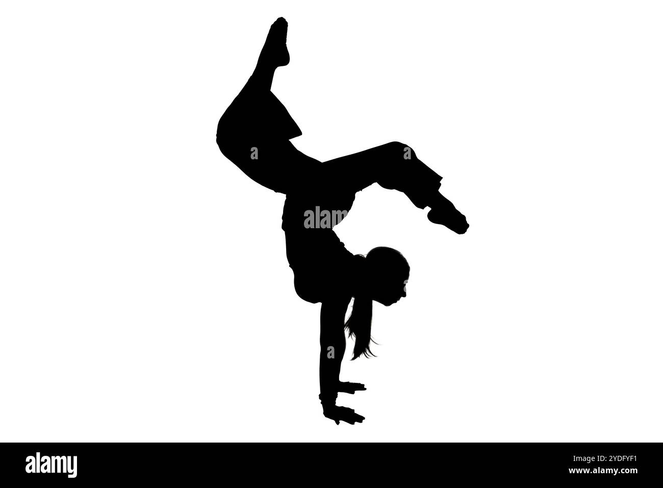 A clear silhouette depicting a person performing a handstand against a ...