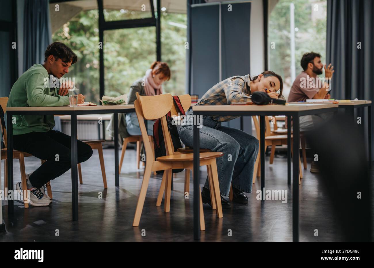 Students studying in classroom with elderly professor observing Stock ...
