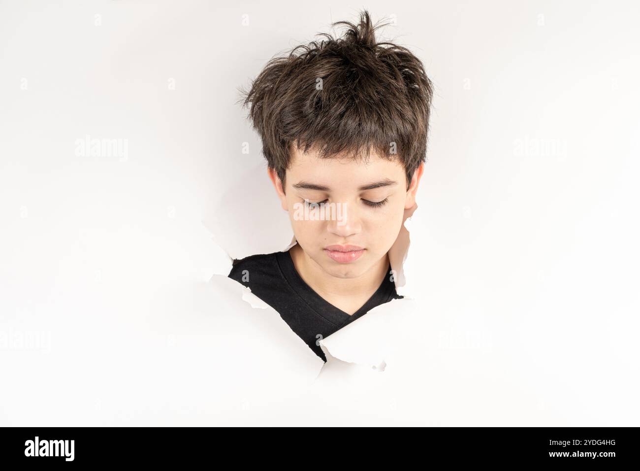 11 year old Brazilian child with only his head on a torn cardboard ...