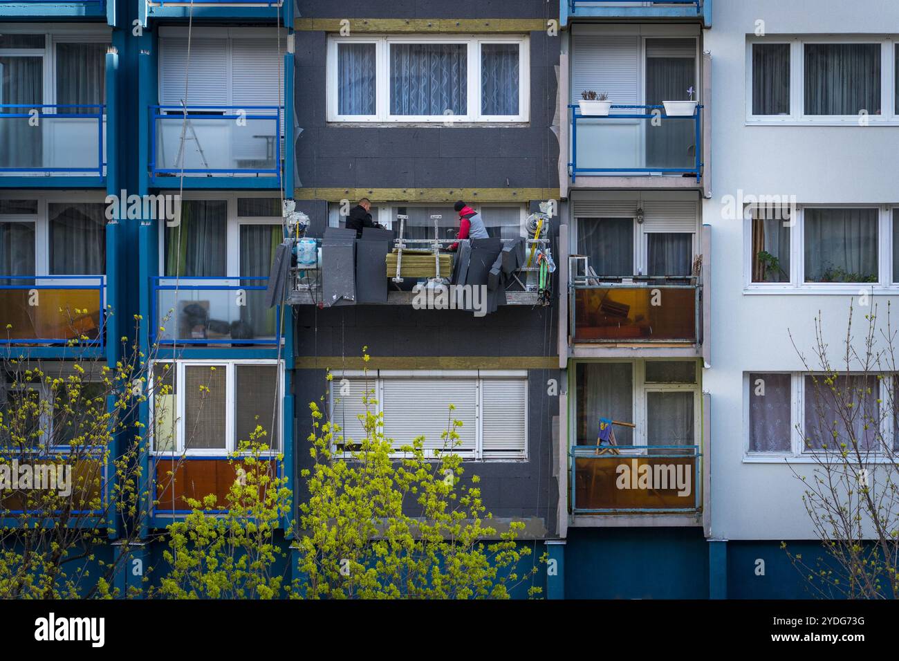 Budapest, Hungary - Workers on a lift installing insulation material on ...