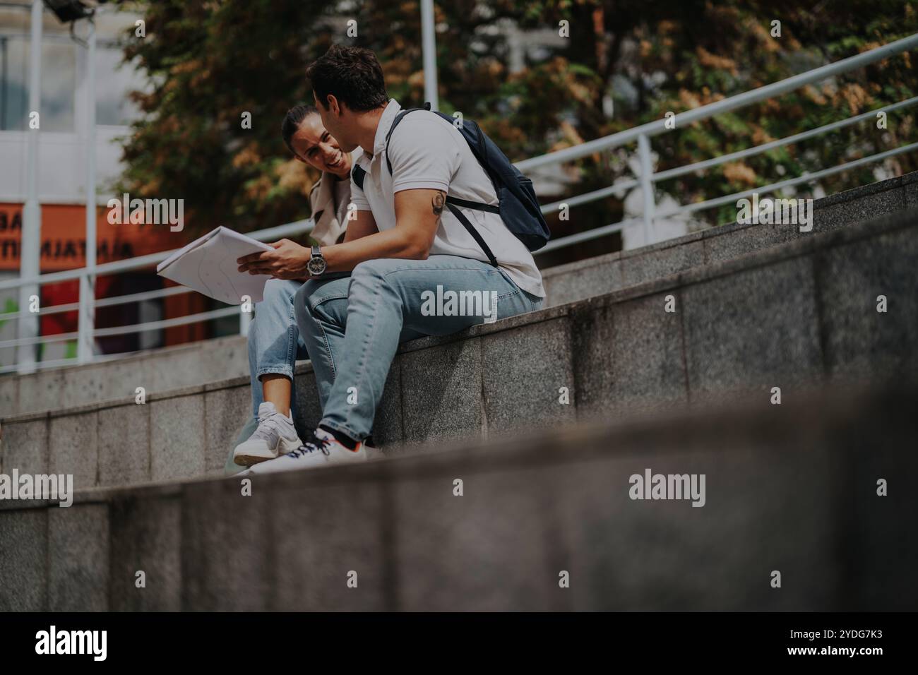 High school students studying outdoors with support from teacher Stock ...