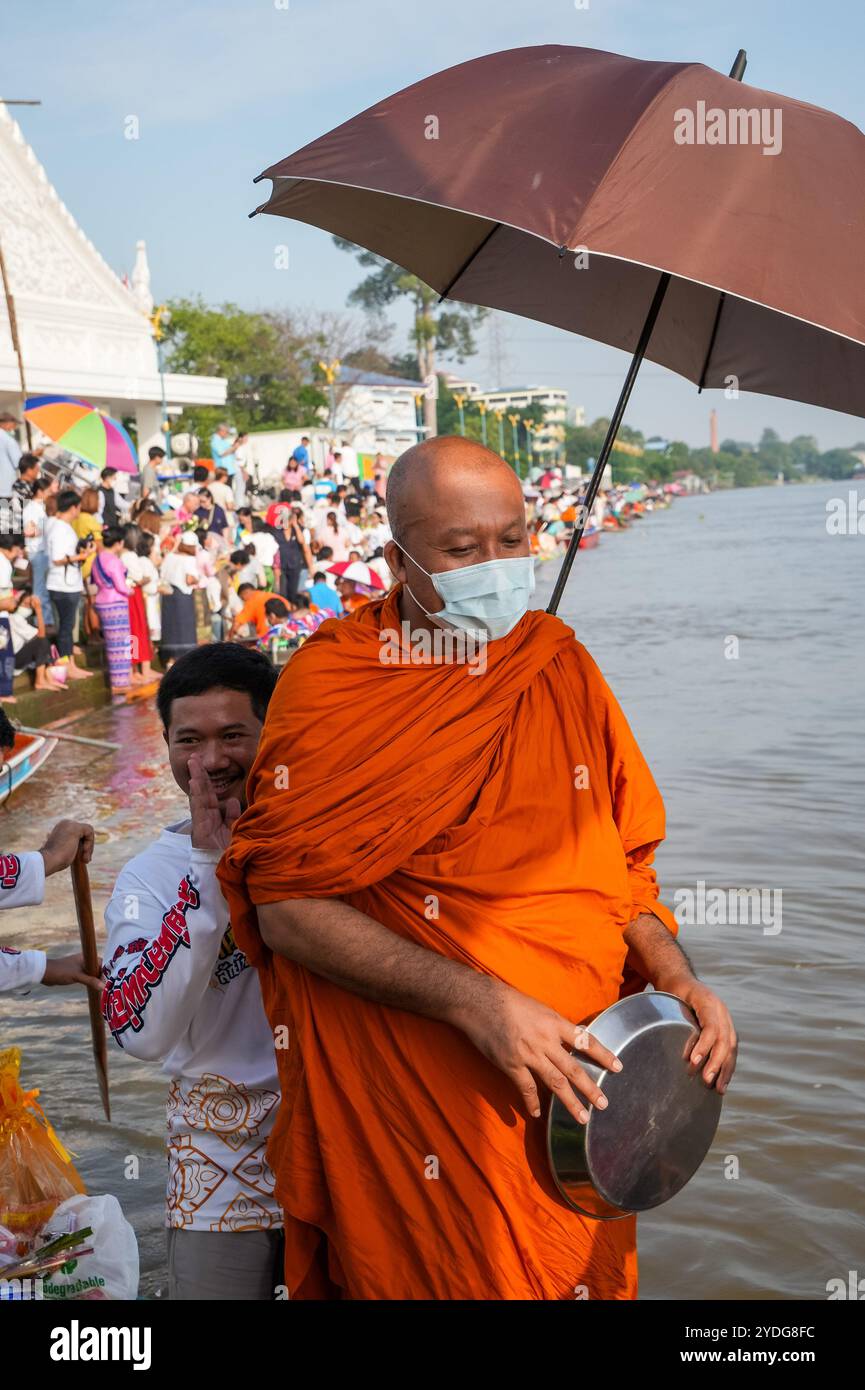 A man who is standing behind the head monk Luang Por Chamnan is seen ...