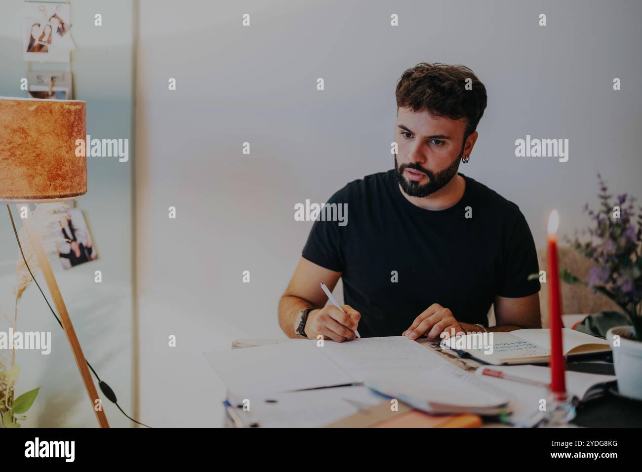 Focused college student studying at home with notebooks and lamp Stock ...