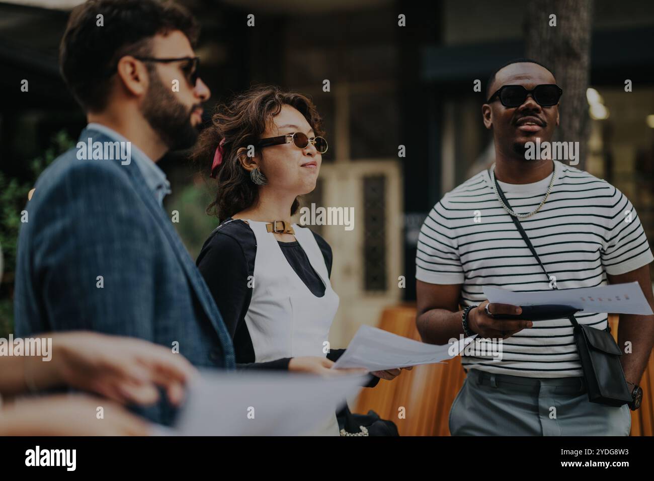 A group of professionals interacts enthusiastically during an outdoor ...