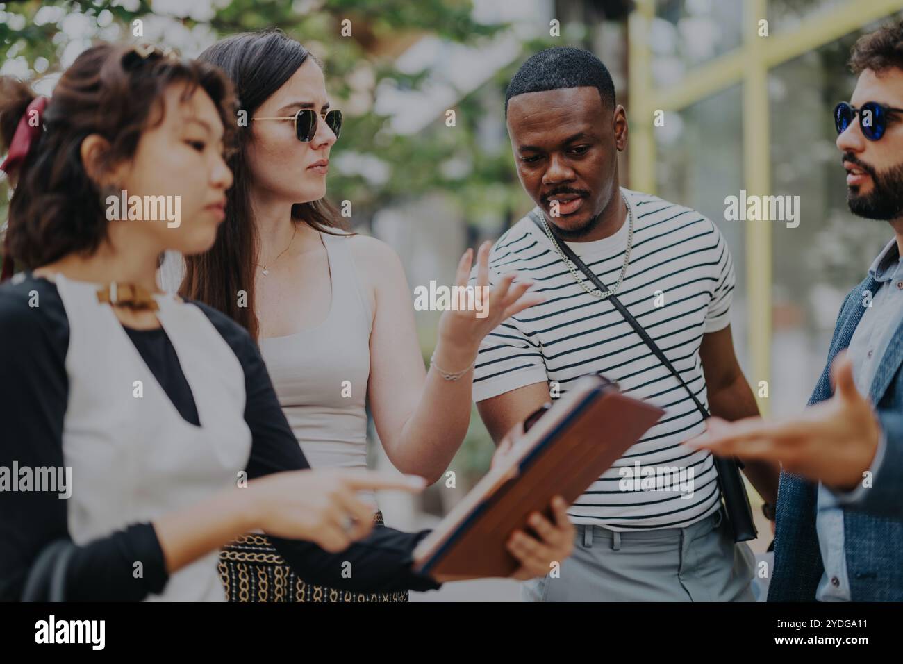 Multicultural team brainstorming project strategies in an urban outdoor ...