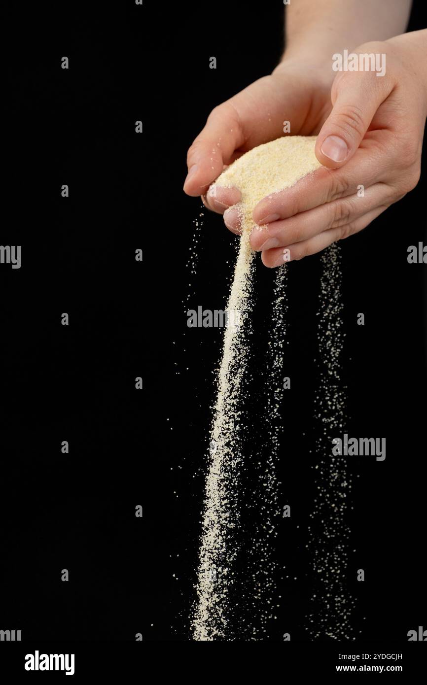 Hands pouring dry semolina durum flour uncooked organic semolina close ...