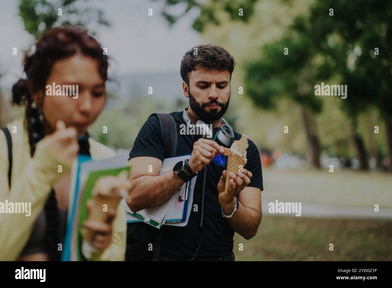 Multicultural students enjoying ice cream in park during class break Stock Photo - Alamy