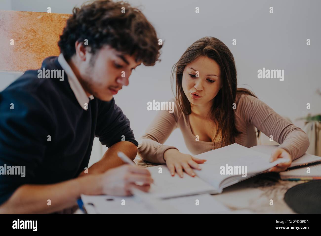 Two college students studying at home with focus and determination ...