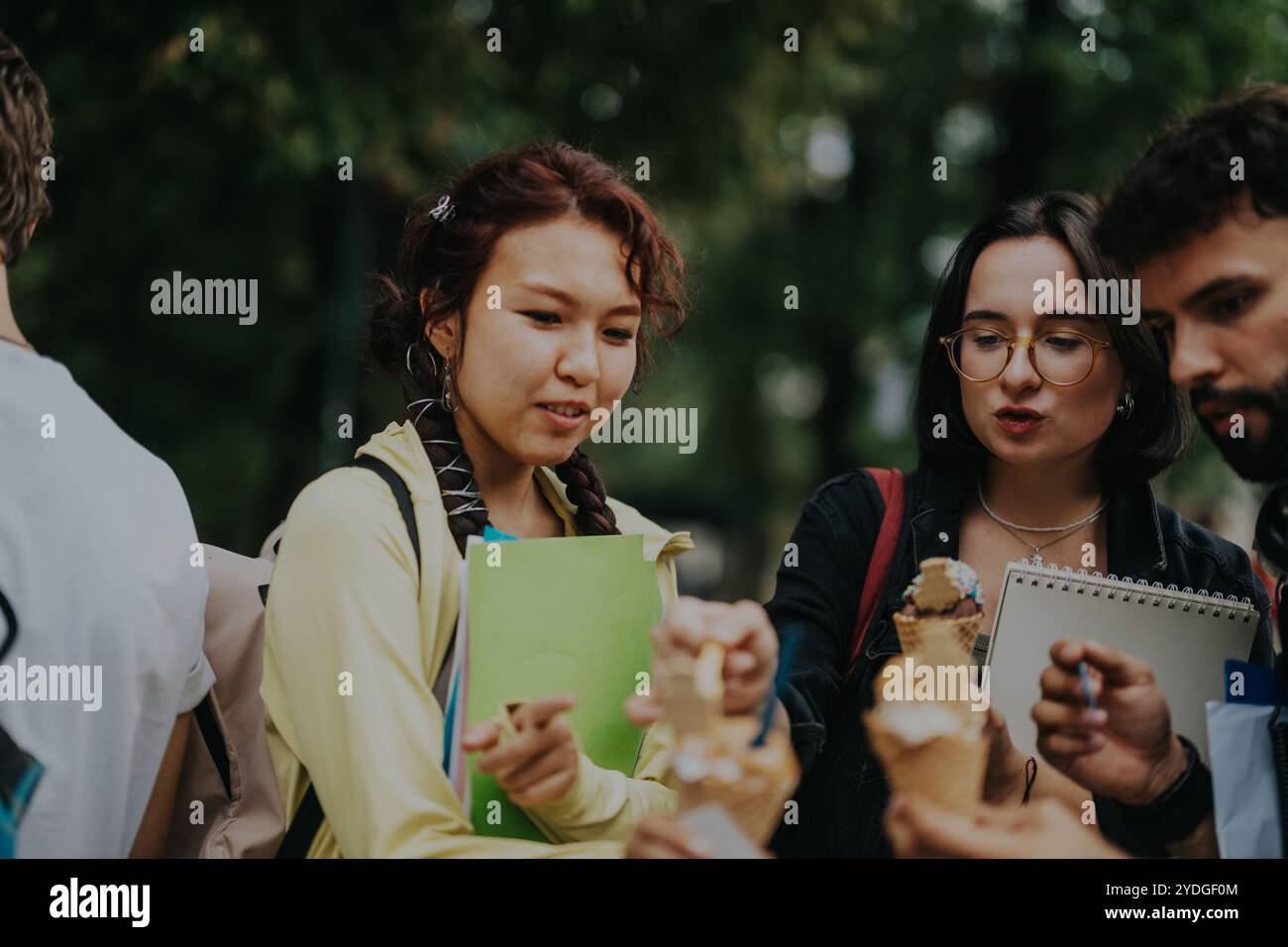 Multicultural students enjoying ice cream in park during school break Stock Photo - Alamy