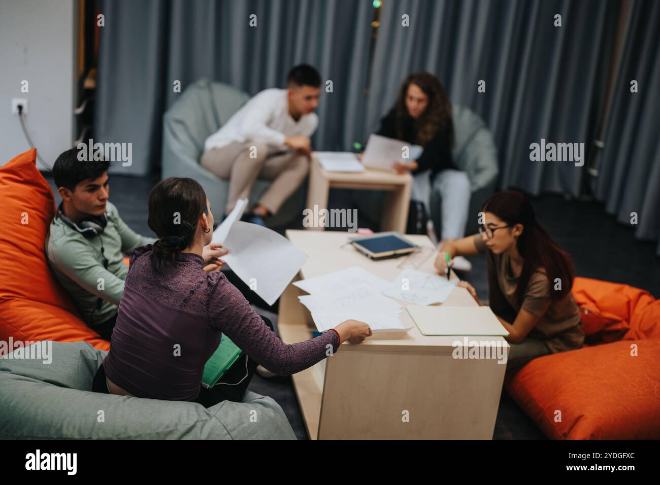 Group of students collaborating in a casual study setting with bean ...