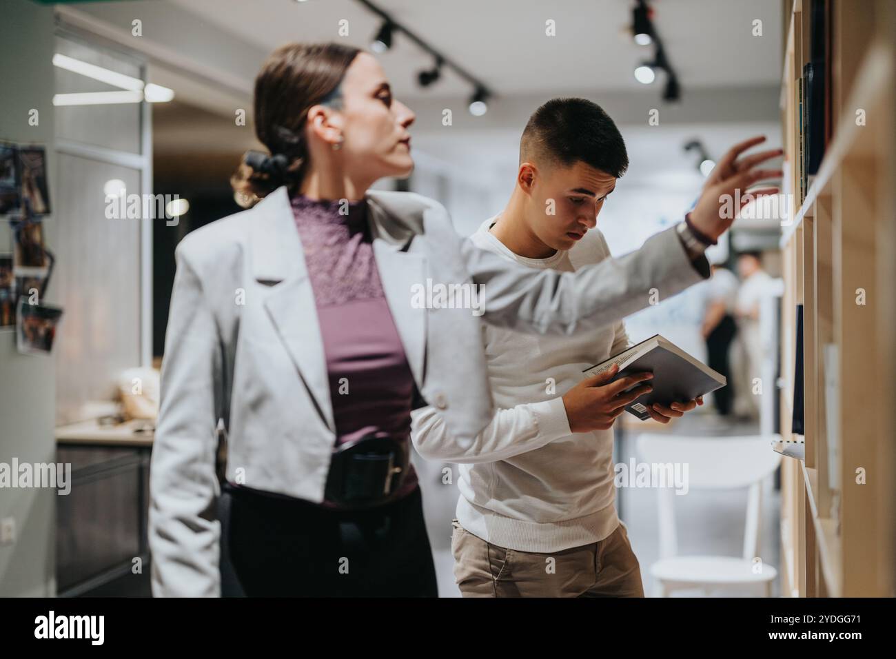 High school students browsing books in modern school library Stock ...