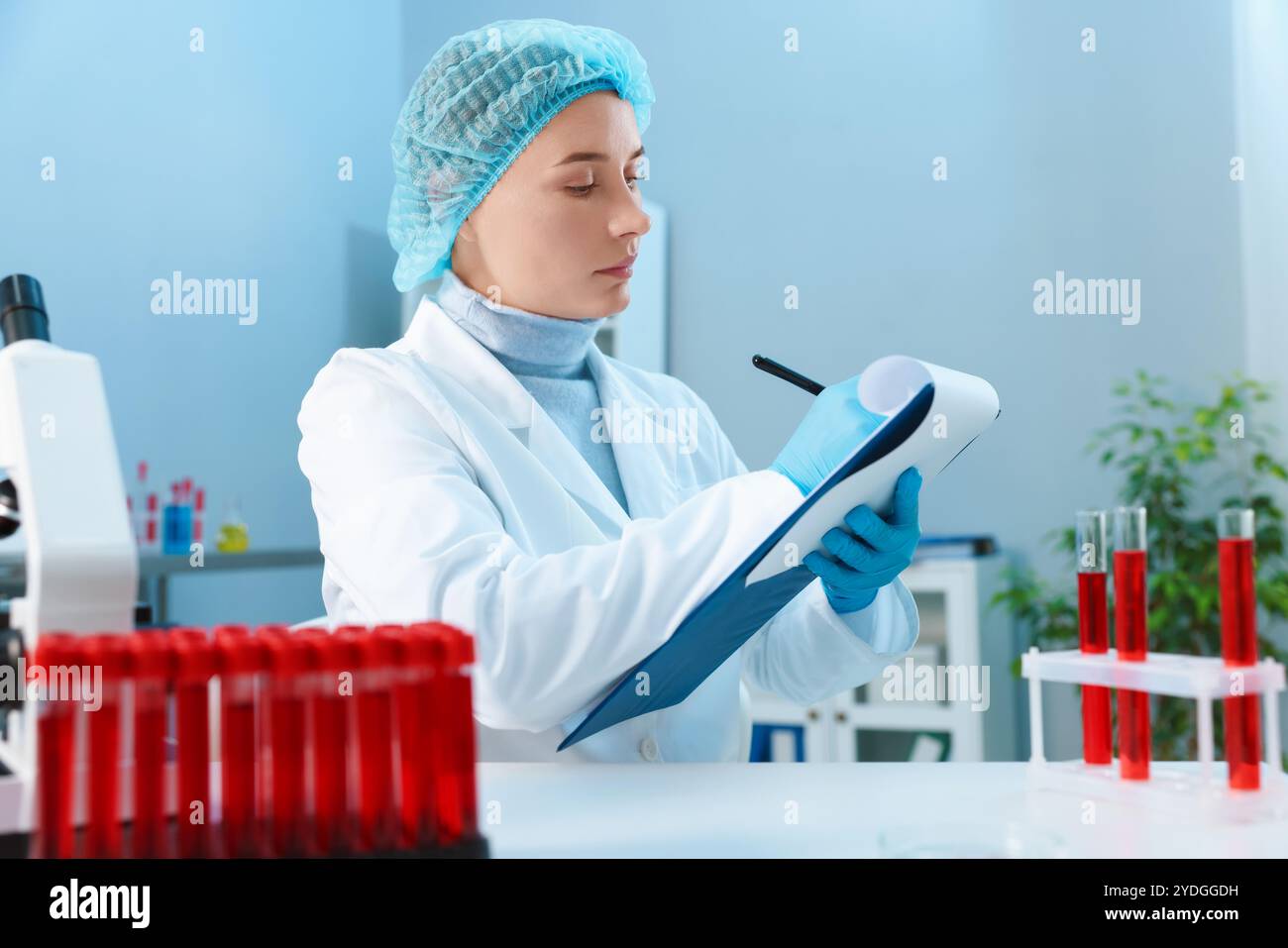 Laboratory testing. Doctor taking notes at table indoors Stock Photo ...