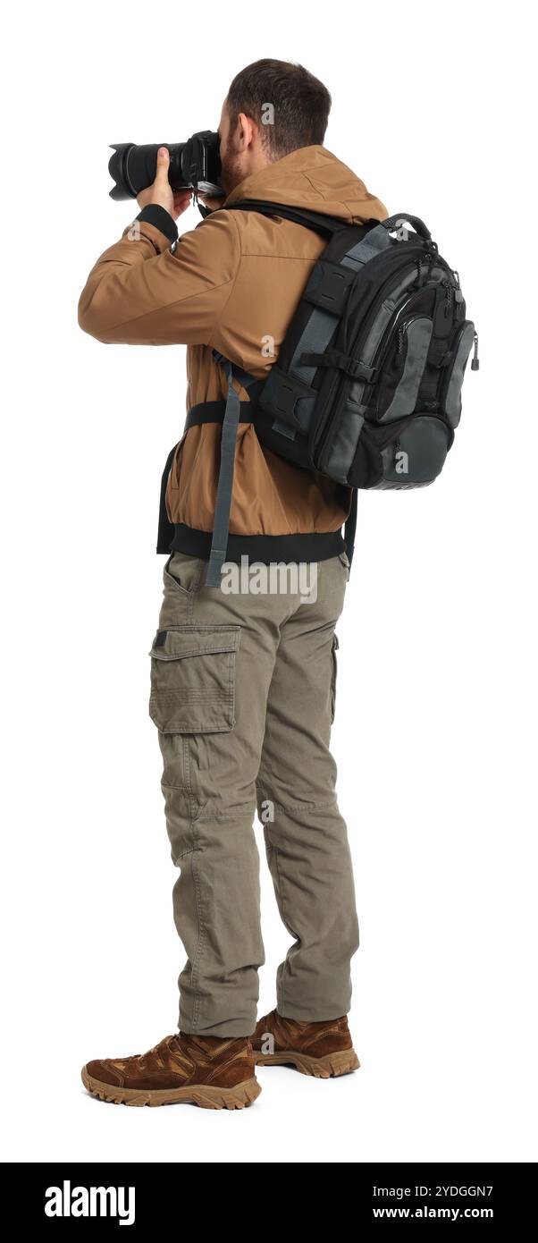 Photographer with backpack and camera taking picture on white ...