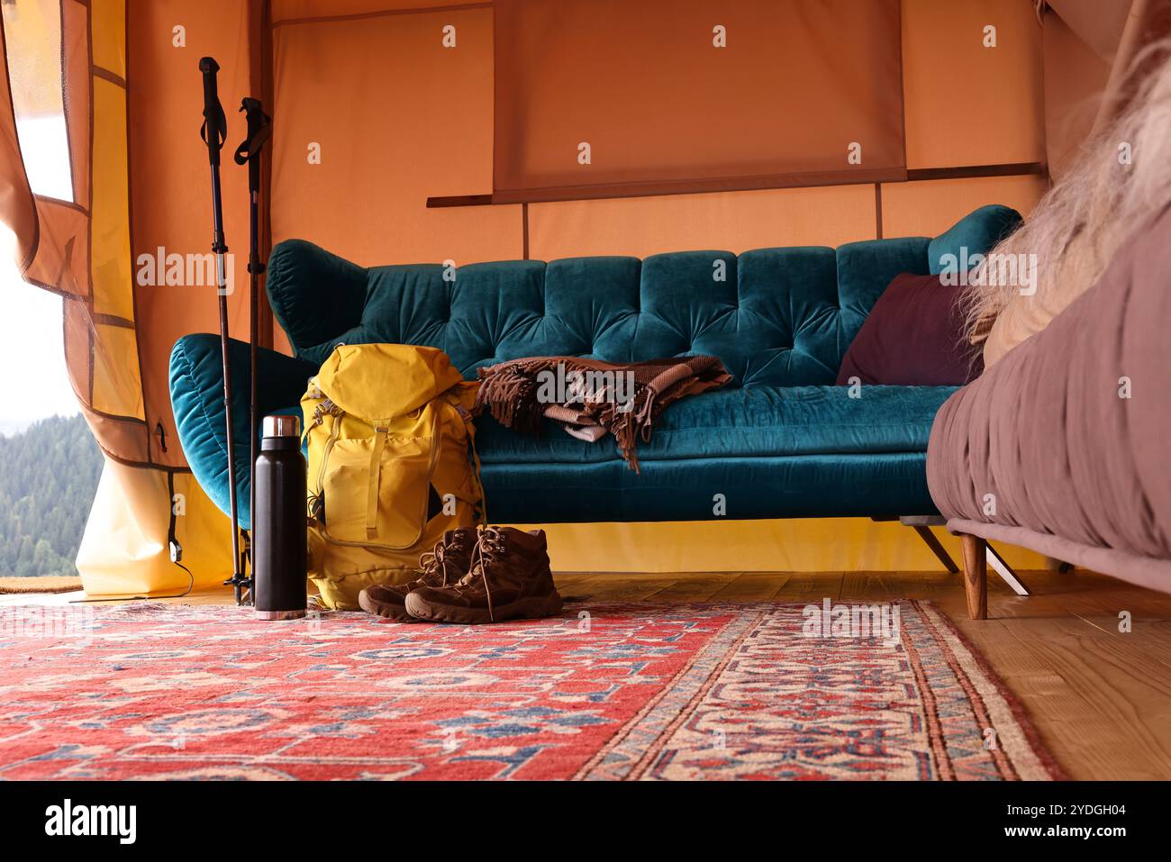 Comfortable sofa and tourist stuff in glamping site Stock Photo - Alamy