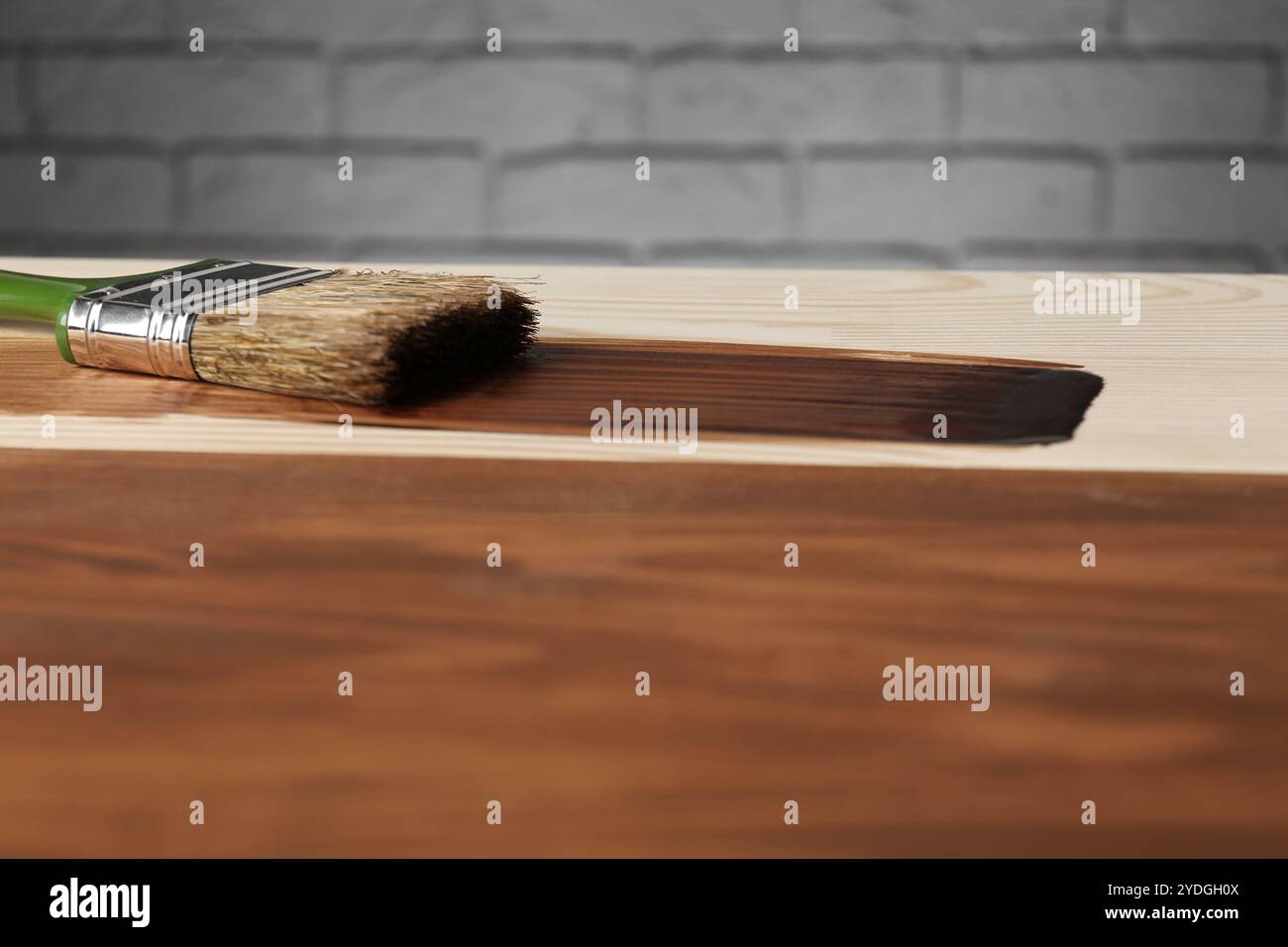Applying walnut wood stain. Brush on wooden surface, closeup Stock ...