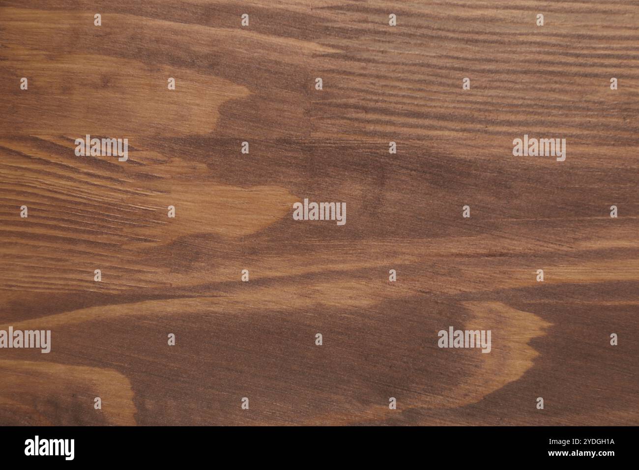 Applying walnut wood stain. Texture of wooden surface as background ...