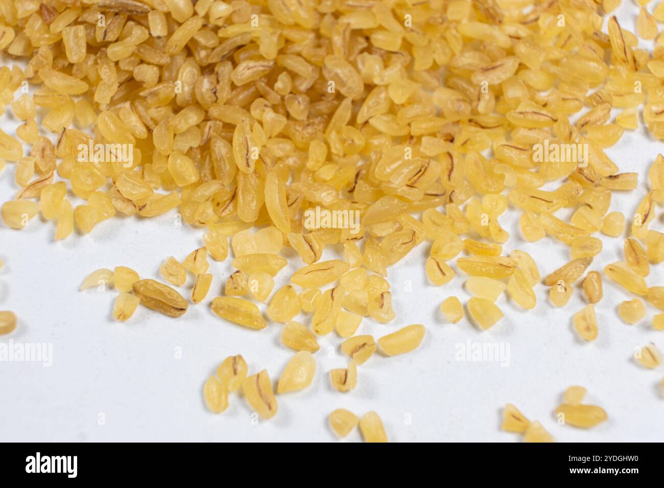 Macro scattered bulgur cracked wheat on a white background Stock Photo ...