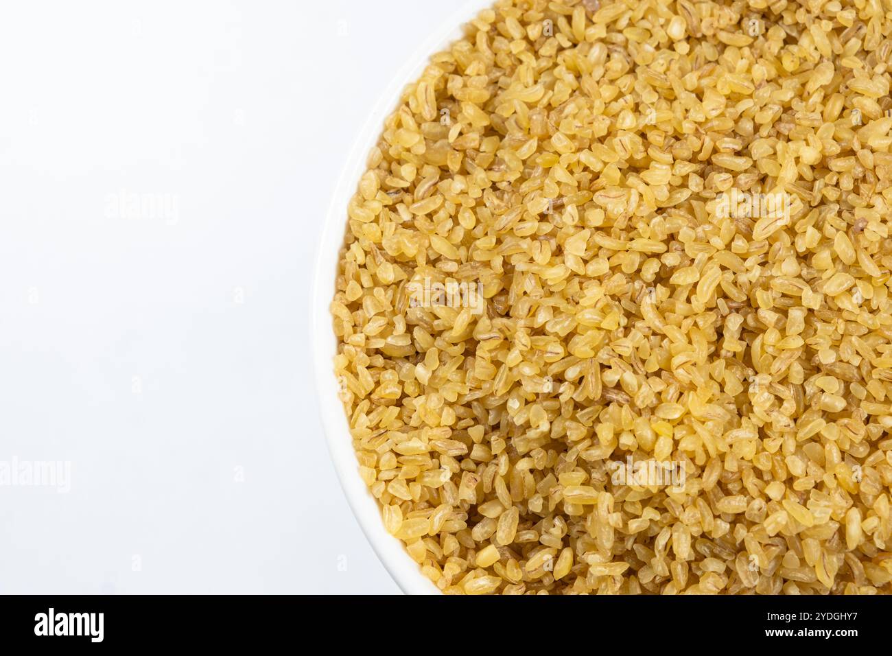 Macro bulgur cracked wheat in a plate on a white background Stock Photo ...