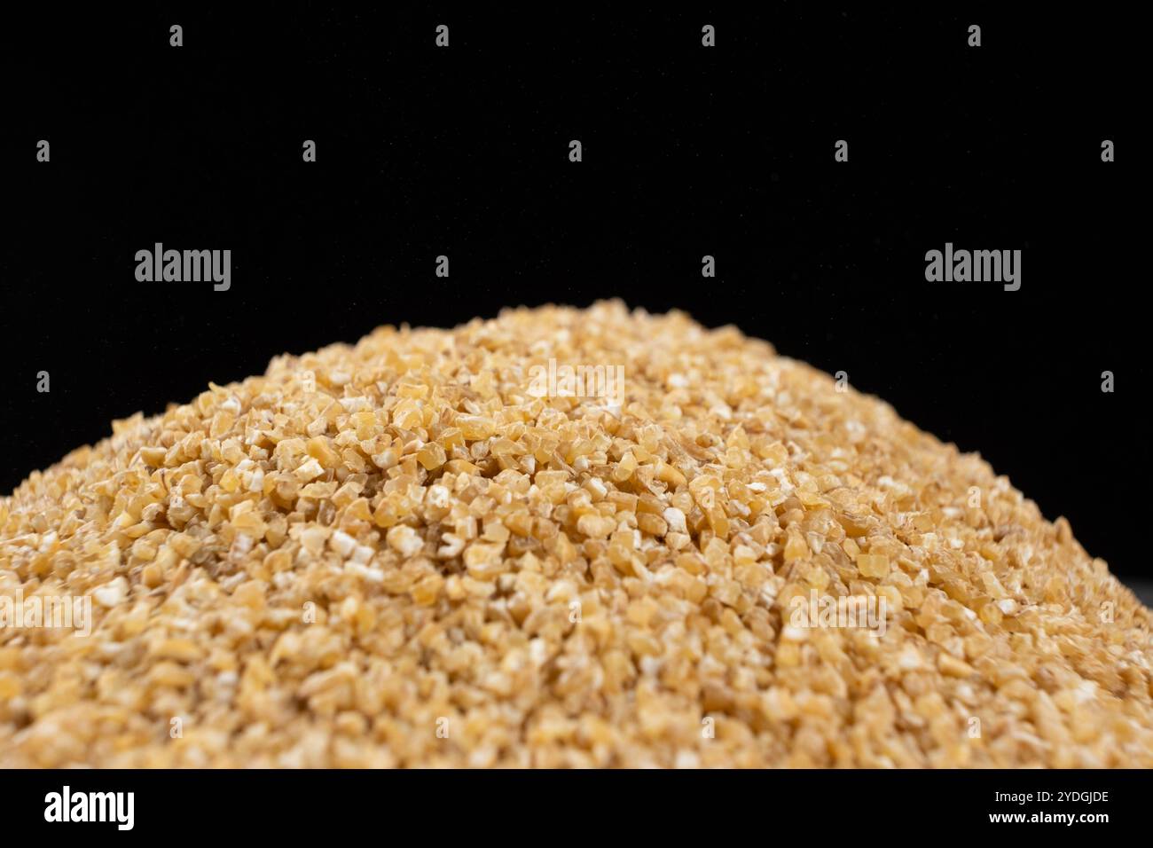 Pile of raw uncooked wheat groats on a black background Stock Photo - Alamy