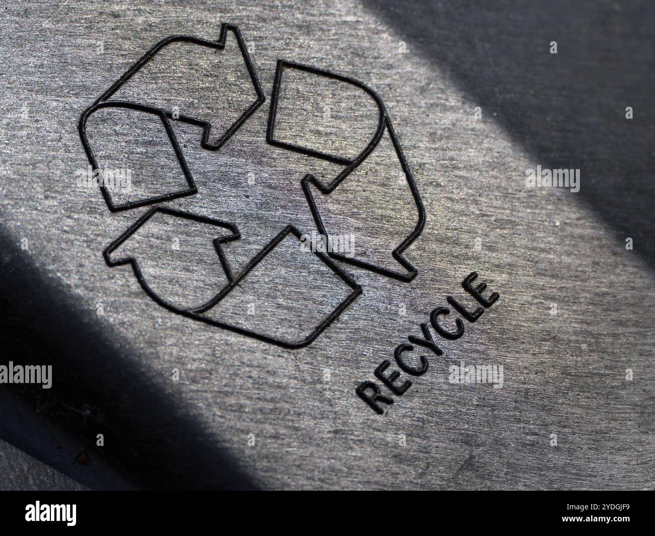 The recycle logo embossed on a piece of black plastic Stock Photo - Alamy