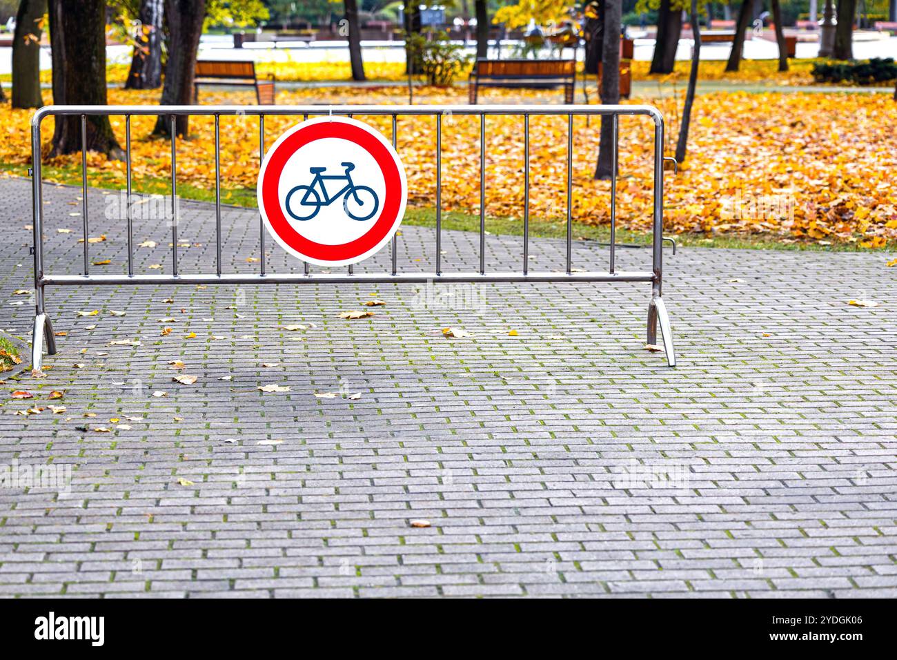 sign prohibiting bicycle riding in a pedestrian zone. fence with a ...