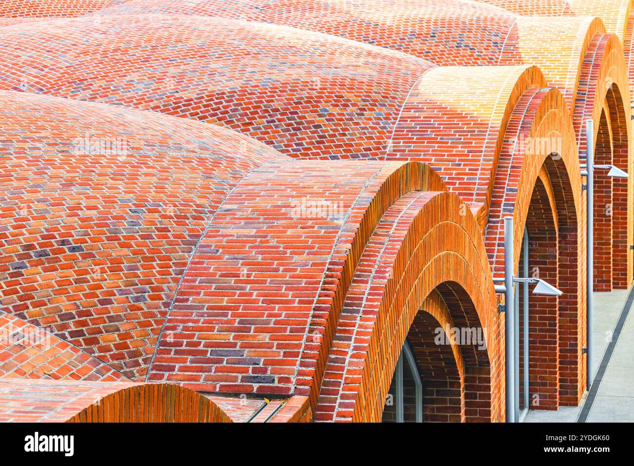 a building with a round roof made of red brick. round roof made of ...
