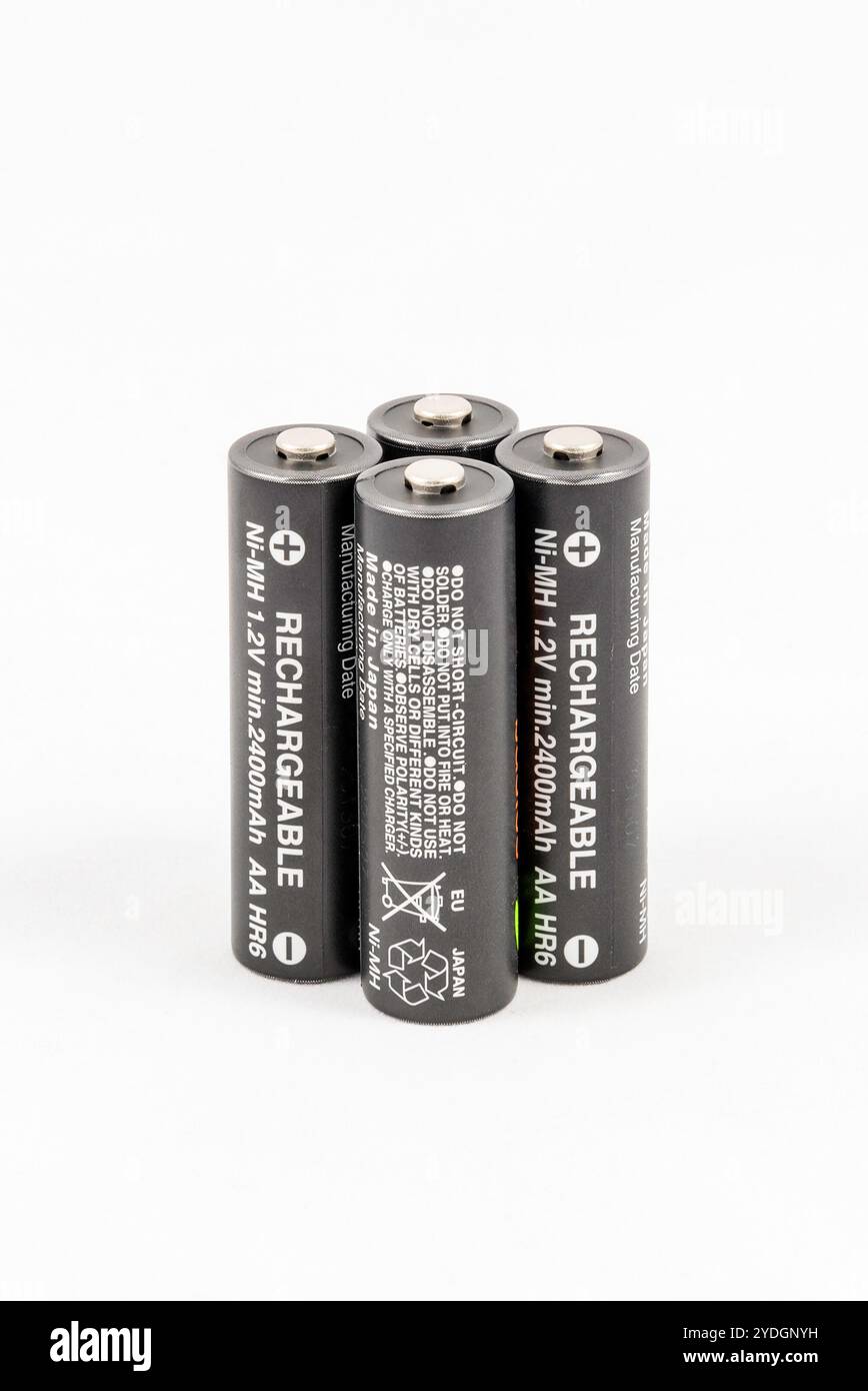 Four unbranded black AA rechargeable batteries, isolated on white ...