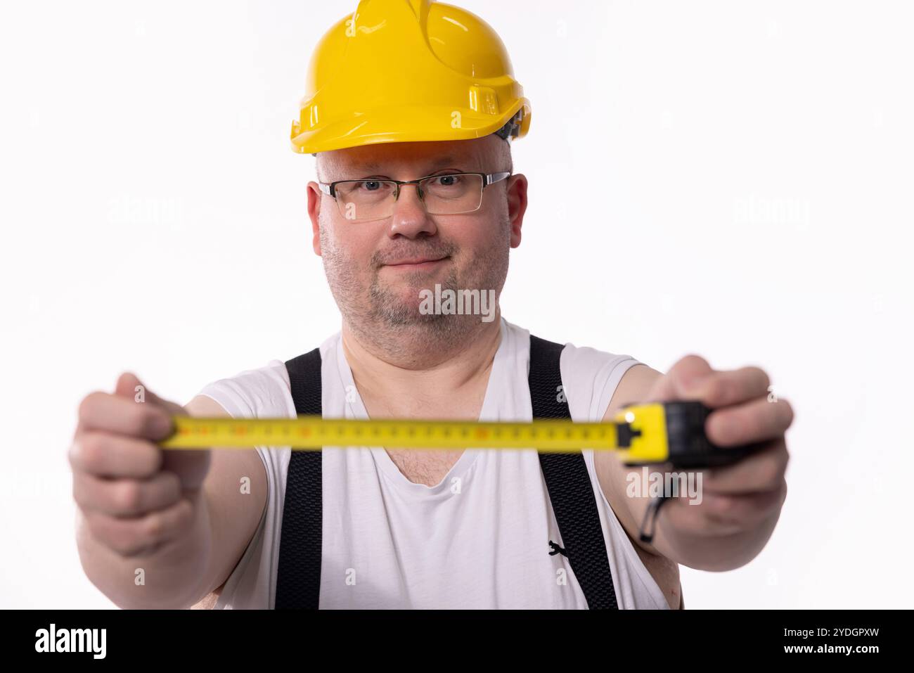 A construction worker is meticulously measuring with a tape measure for ...