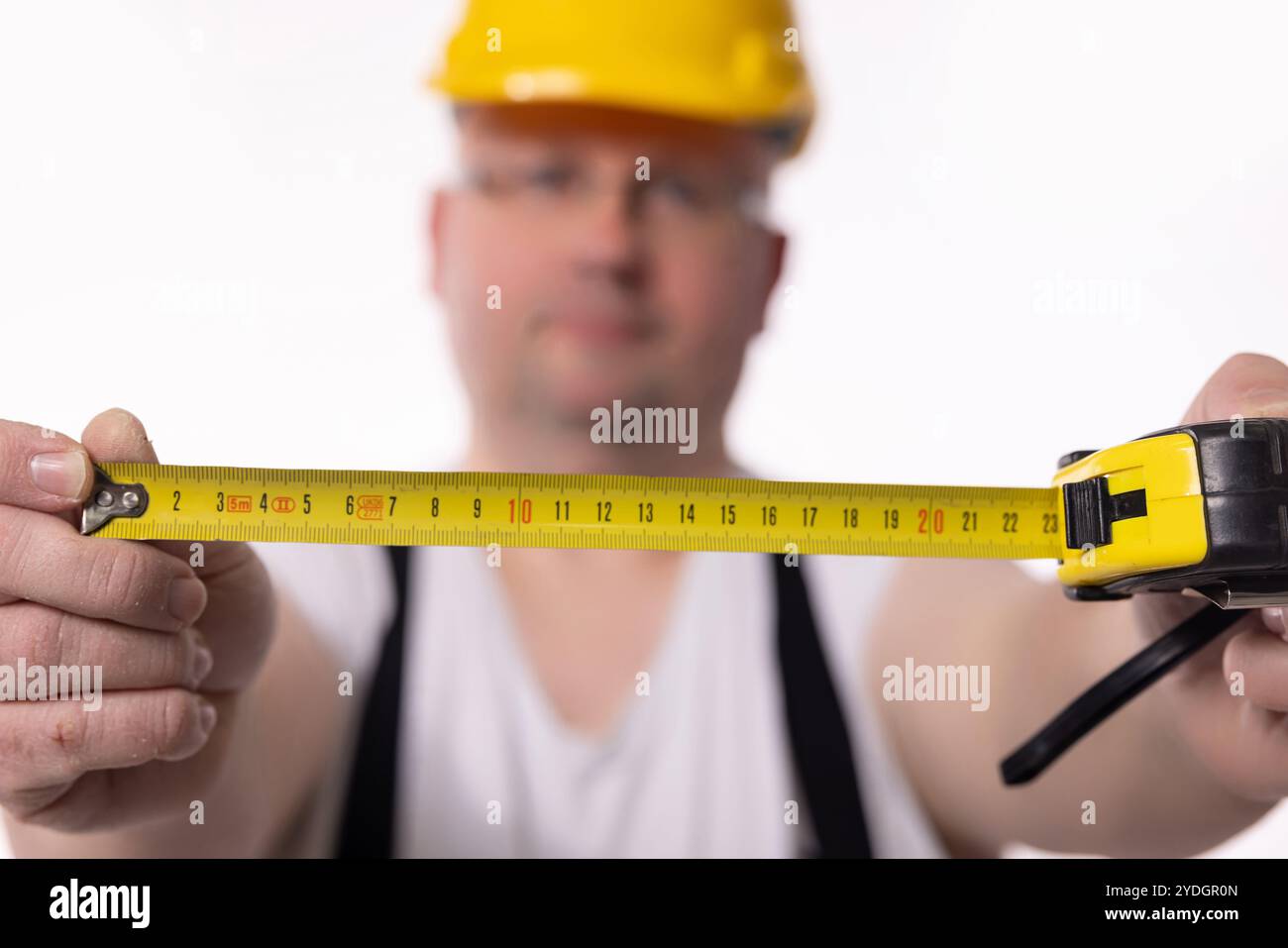 A construction worker diligently using a measuring tape with incredible ...