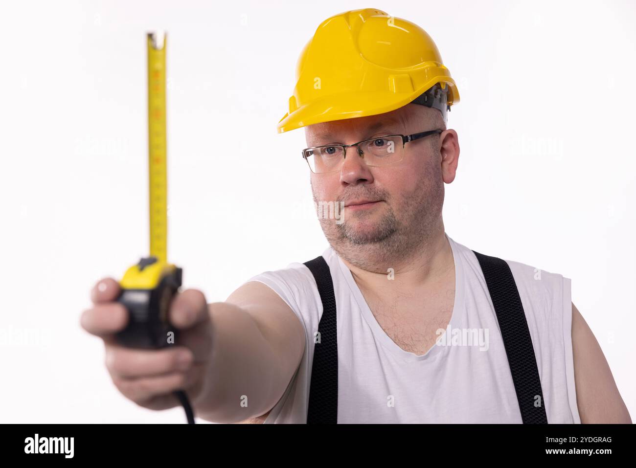 A Construction Worker is meticulously Measuring with a Tape Measure for ...