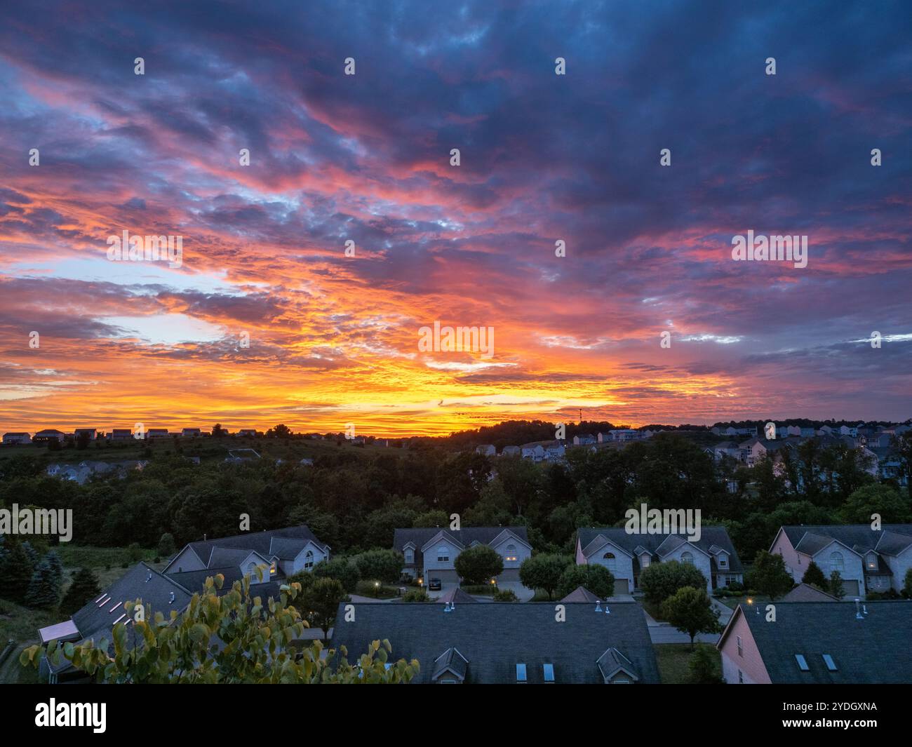 A breathtakingly colorful sunset lights up the summer sky, casting ...