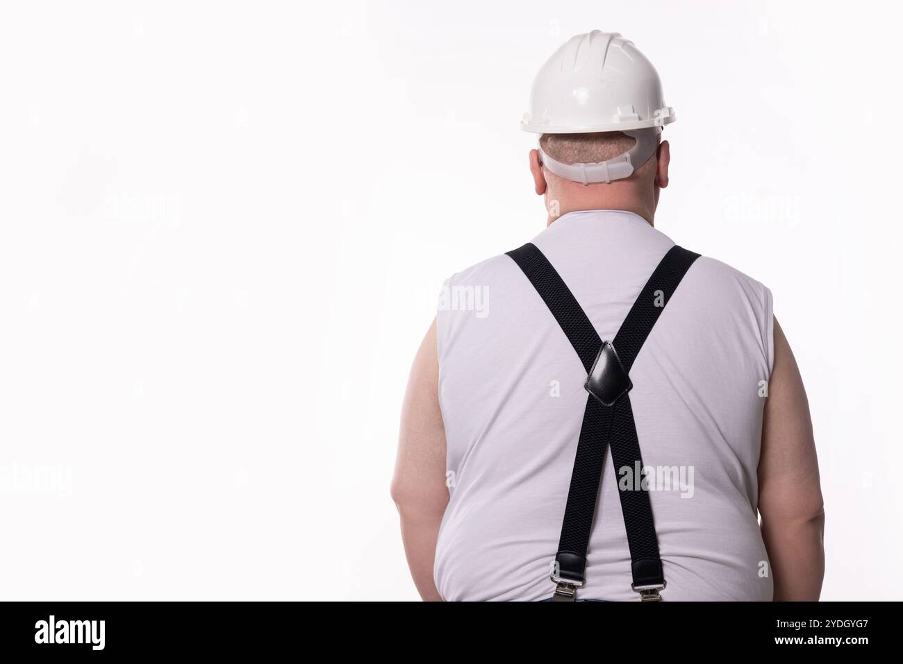 A construction worker wearing a safety helmet can be seen in a profile ...