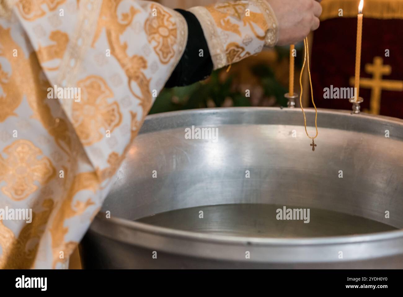 Ritual Baptism Ceremony with Golden Vestments and Cross Stock Photo - Alamy