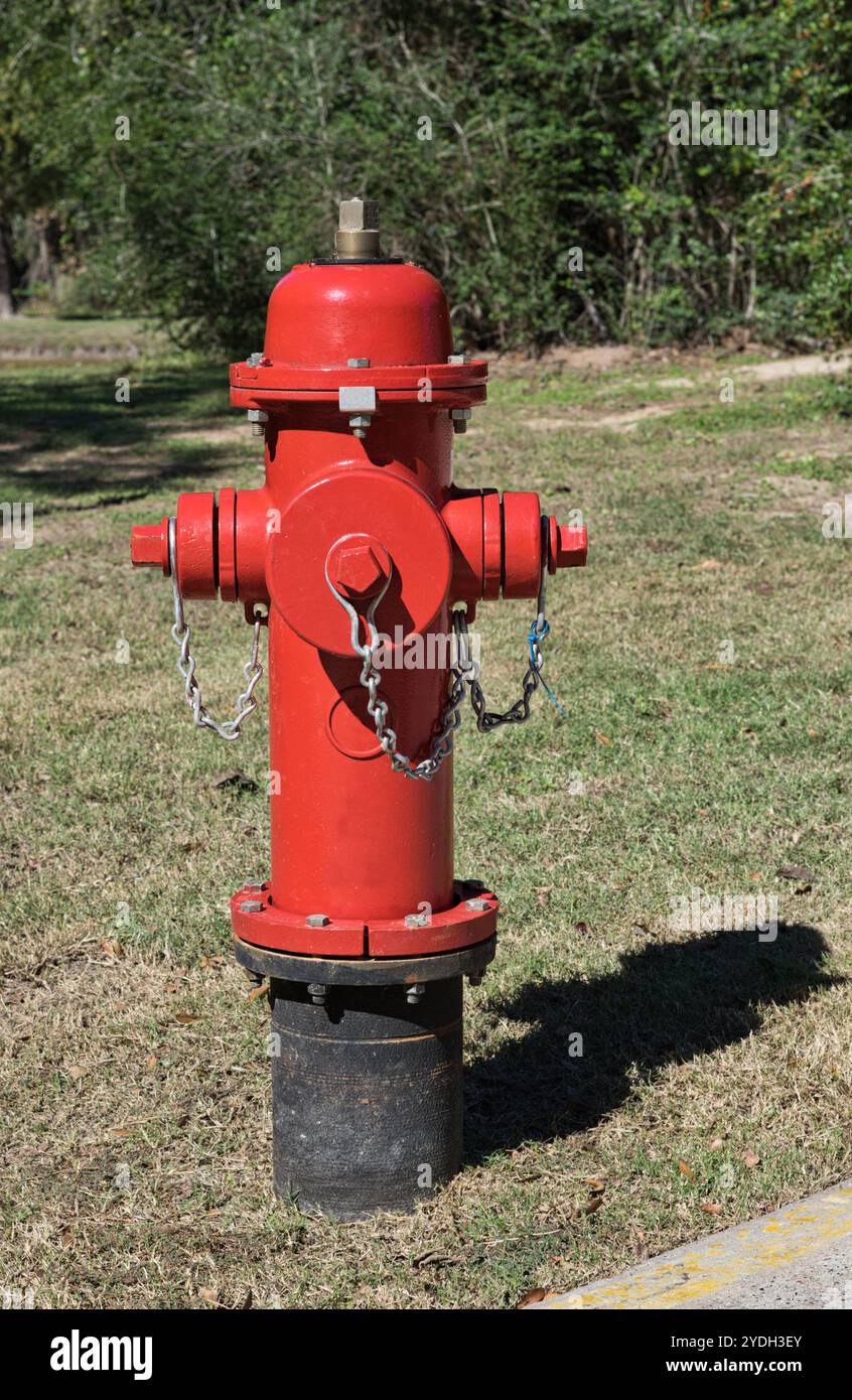 Red fire hydrant water supply fireplug with shield body on lawn by ...