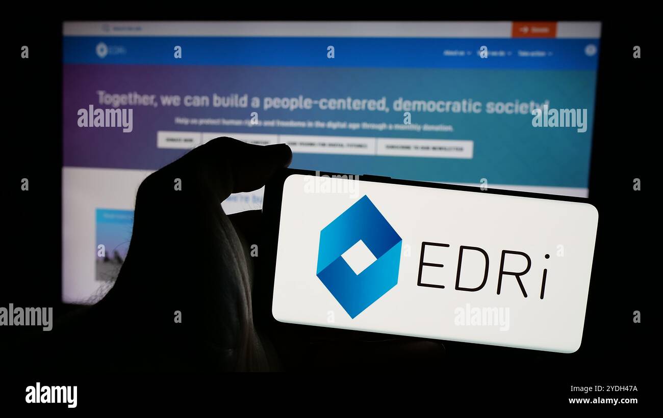 Person holding mobile phone with logo of advocacy group European ...