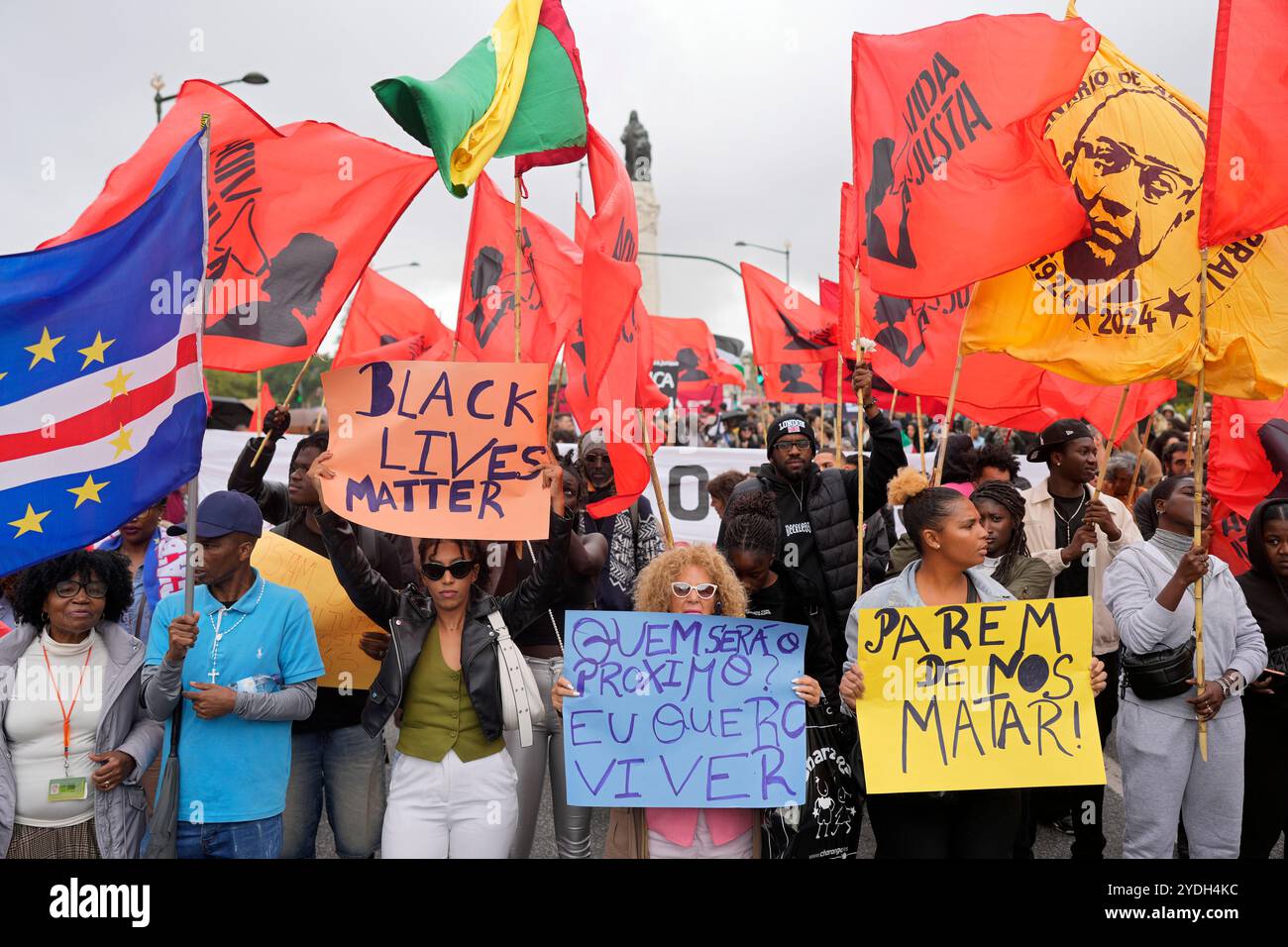 People carry signs and flags during a protest against racism and police ...