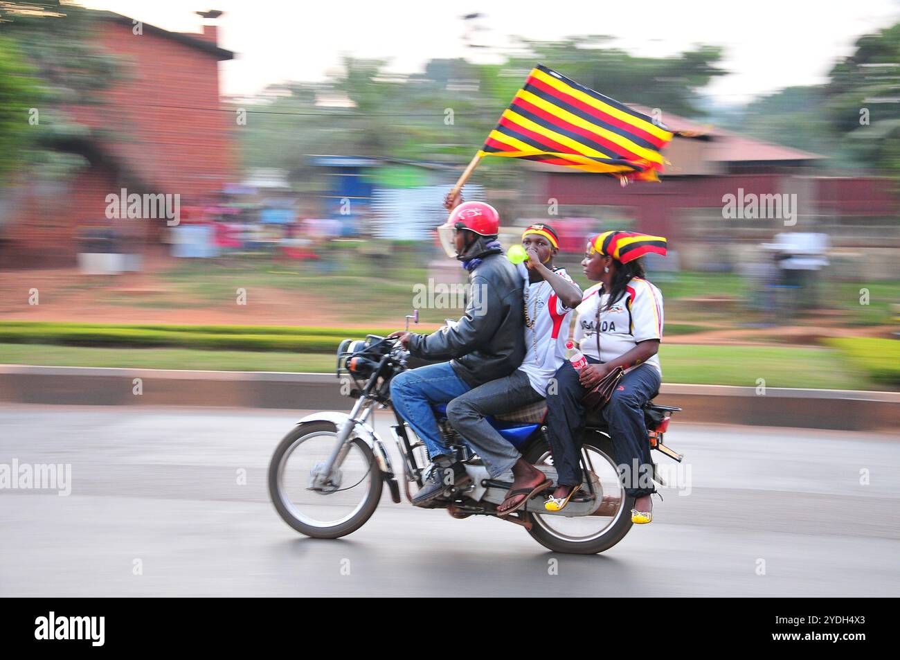 Uganda Football funs ride on a motorcycle celebrating a win for the ...