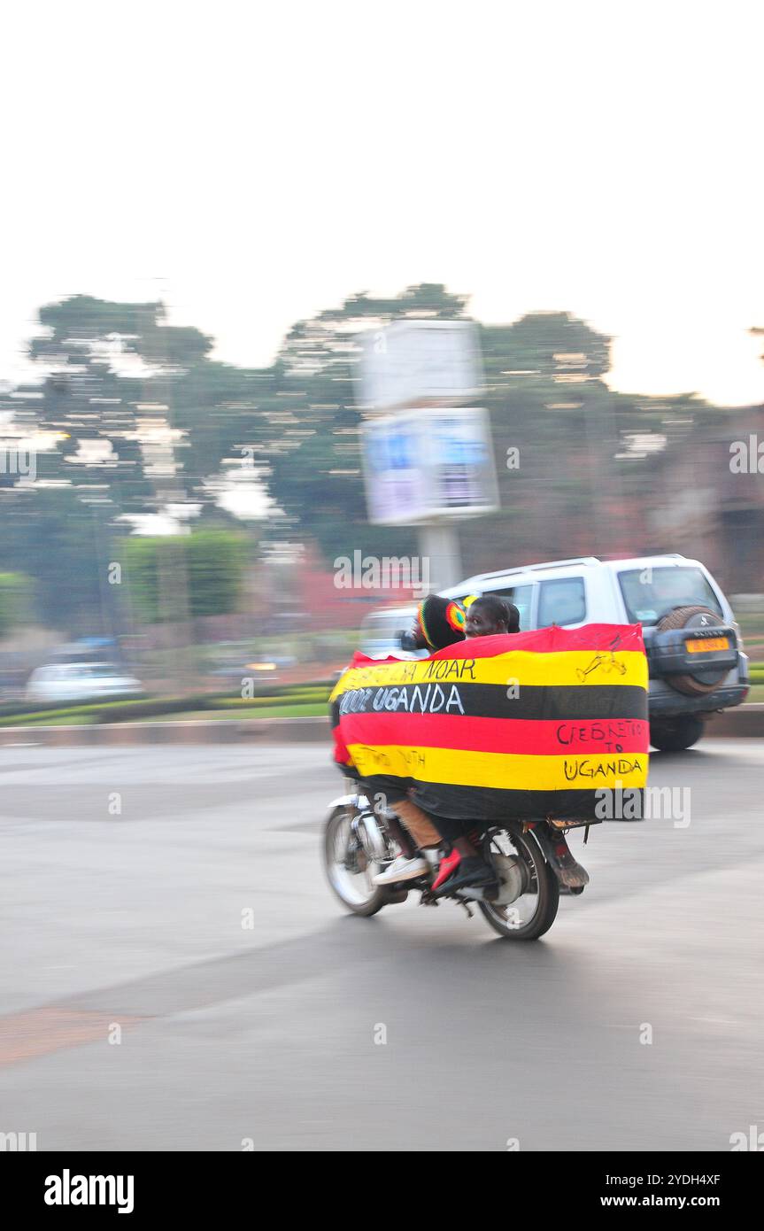 Uganda Football funs ride on a motorcycle celebrating a win for the ...