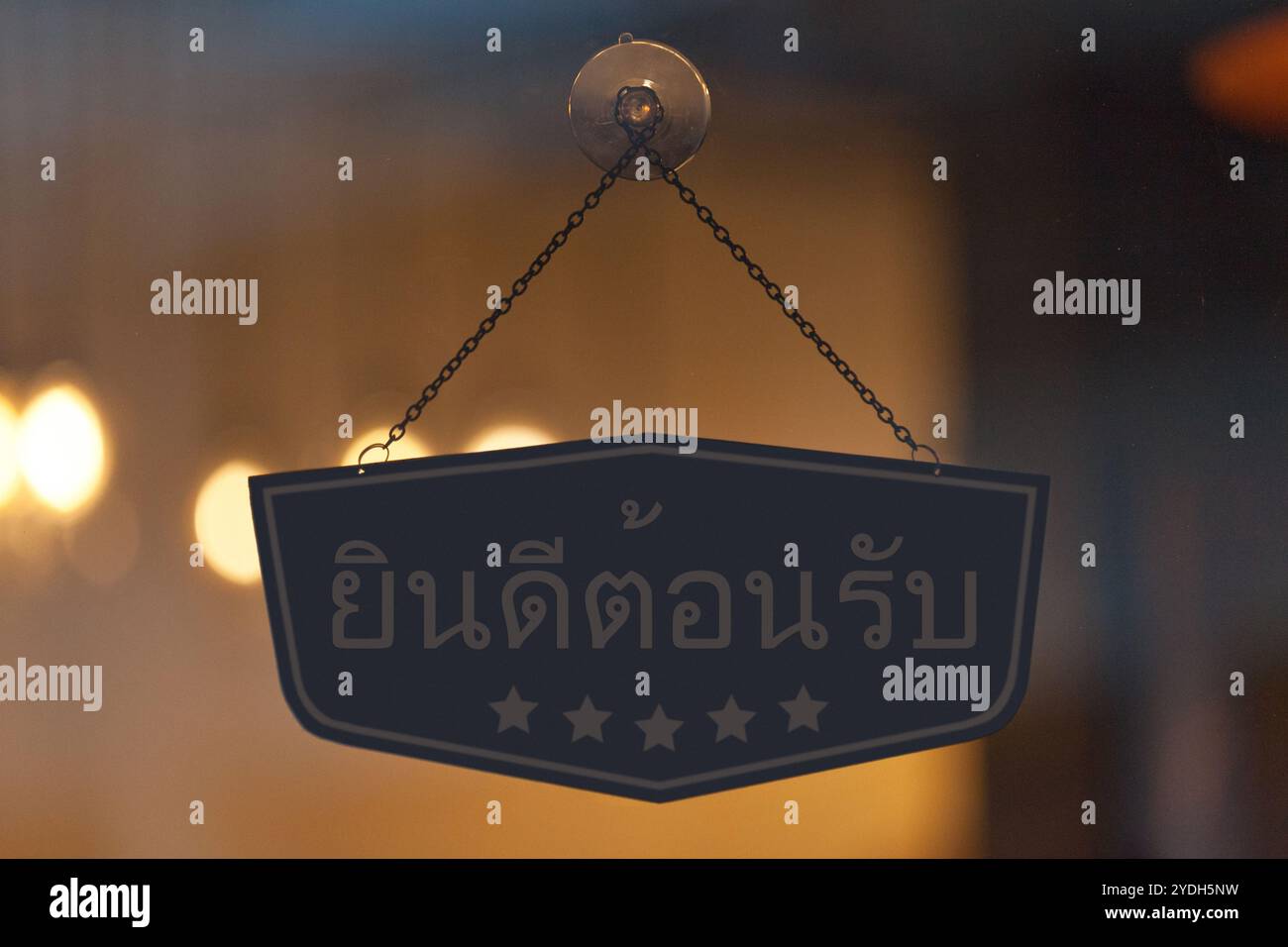 Sign in a window with written in Thai "ยินดีต้อนรับ", meaning "Welcome ...