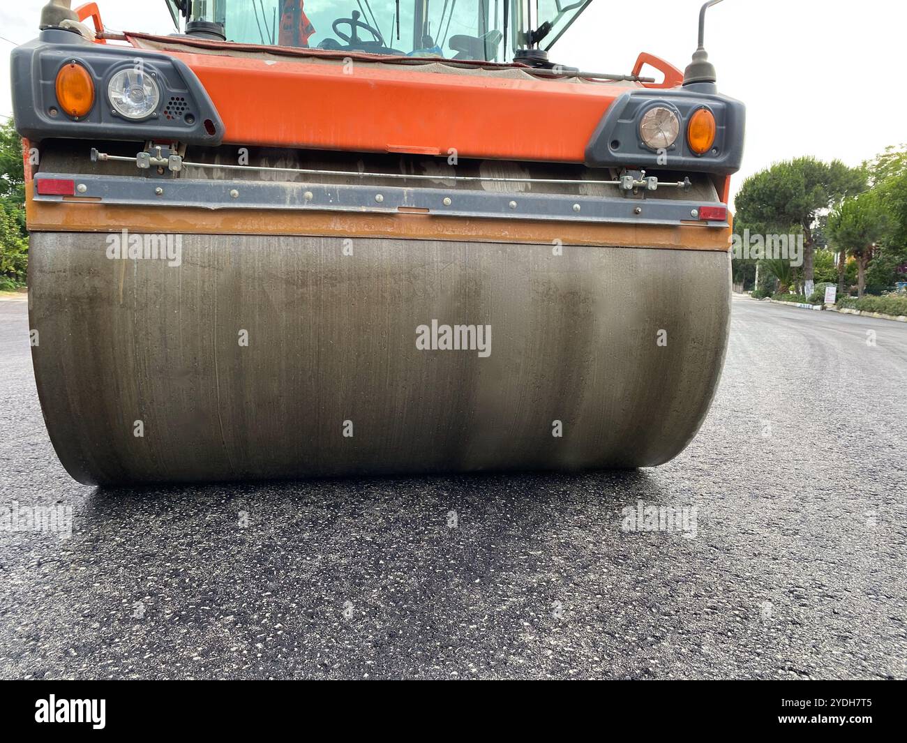 Compact steamroller flatten out the asp Stock Photo - Alamy