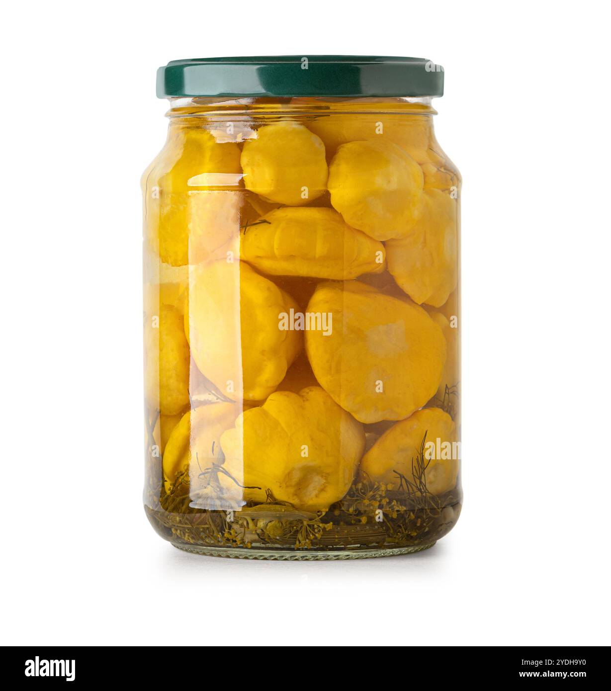 yellow pattisons in glass jar, sour pickled vegetables with spices ...