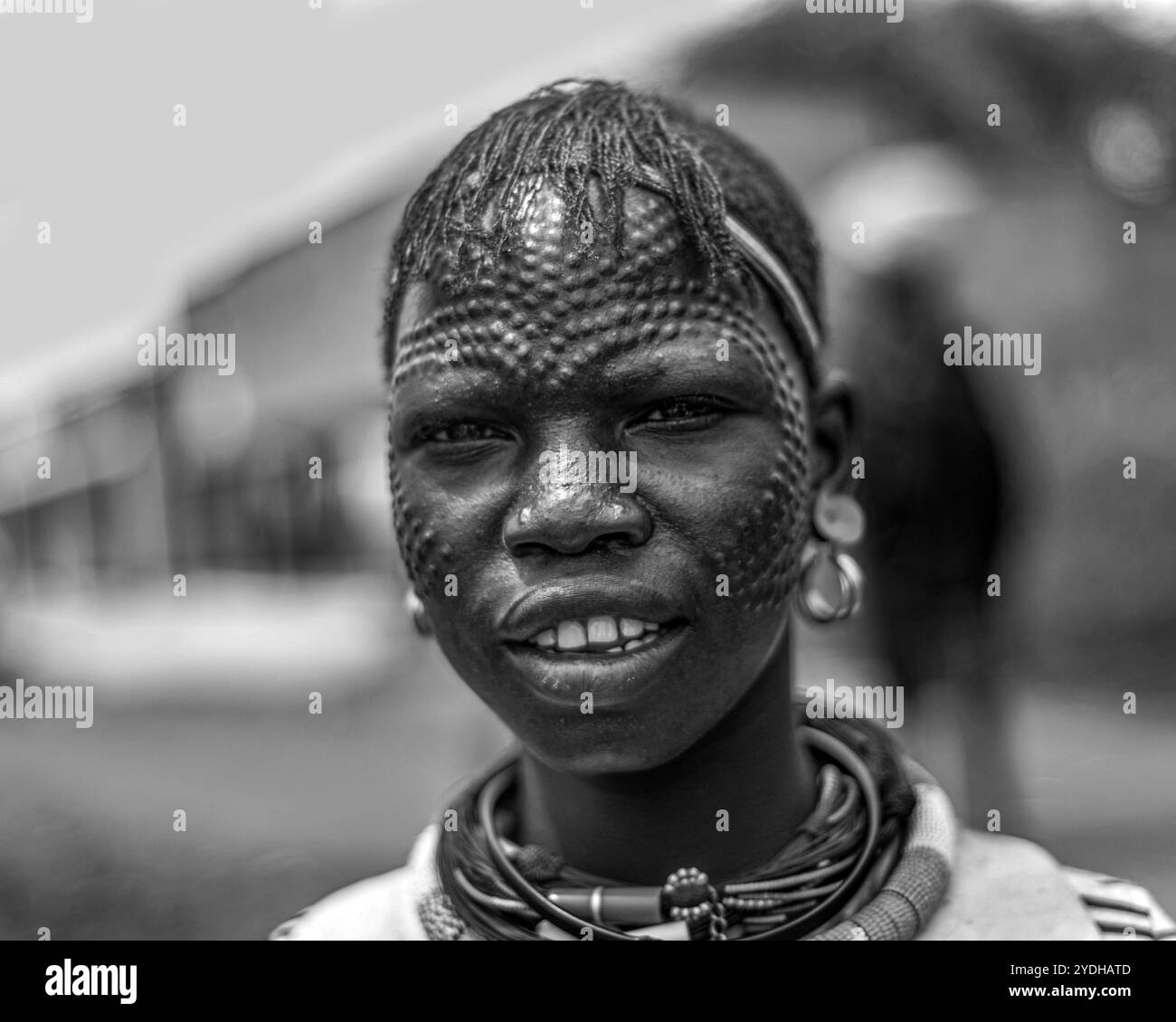 A smiling Karimojong girl with face tattoos in Kotido, Karamoja Uganda ...