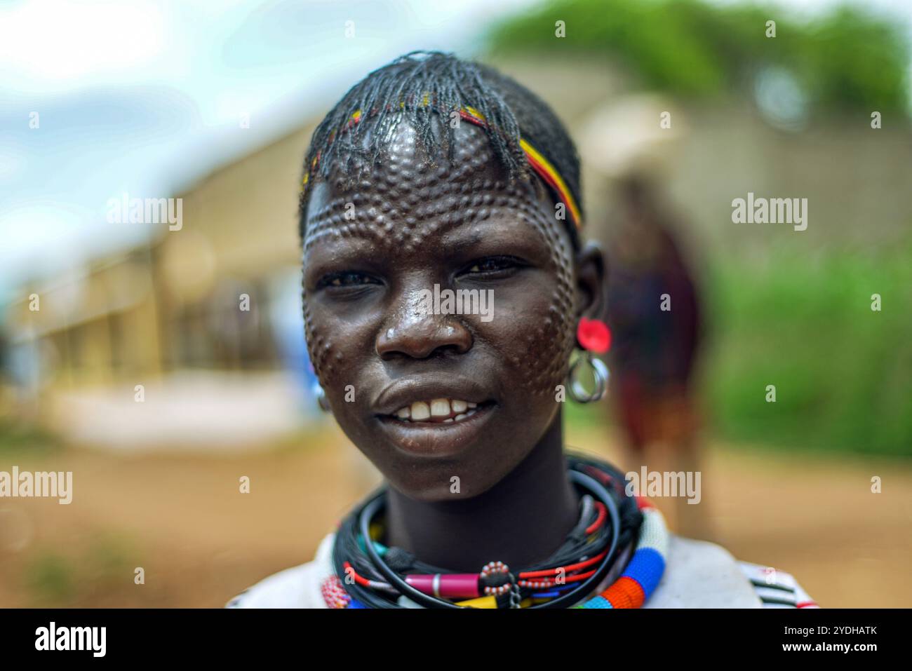 A smiling Karimojong girl with face tattoos in Kotido, Karamoja Uganda ...