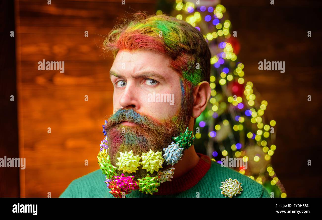 Christmas beard decorations. Handsome Christmas man with many Christmas ...