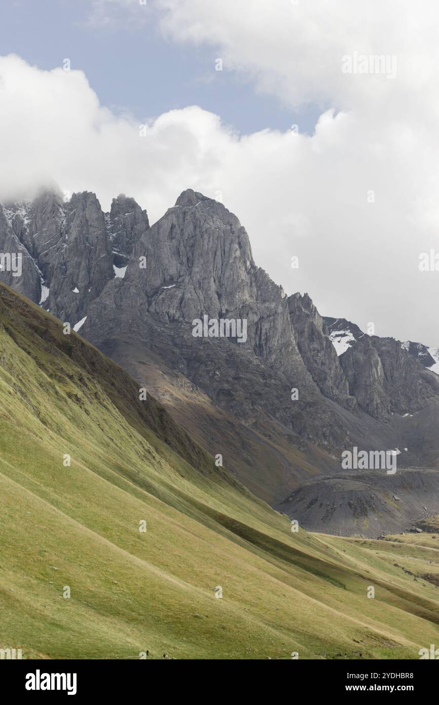 a breathtaking view of a towering mountain range, where steep, jagged ...