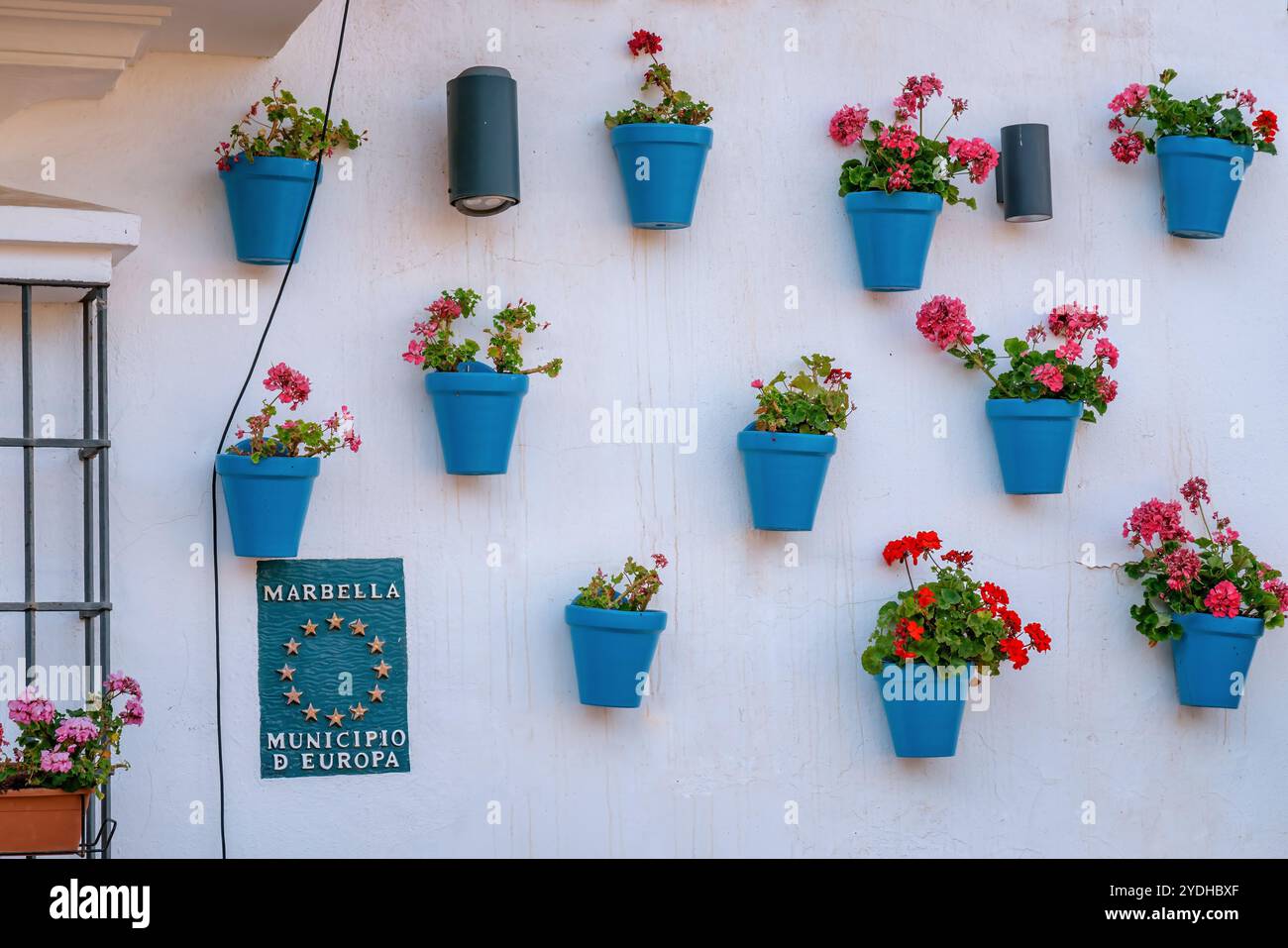Charming blue flower pots hanging on a white wall in Marbella, Spain ...