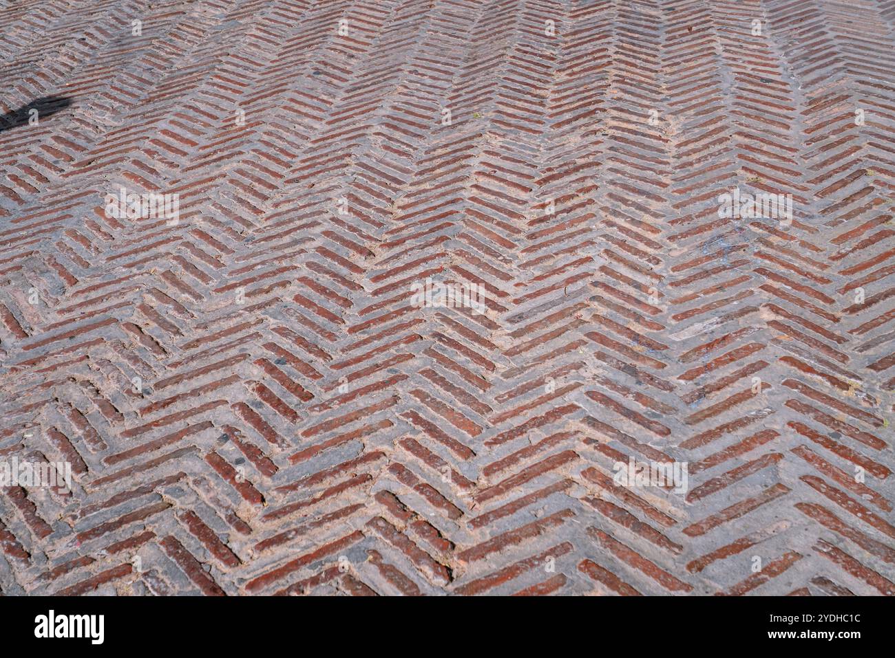 Red brick pavement forming a herringbone pattern, a typical element of ...