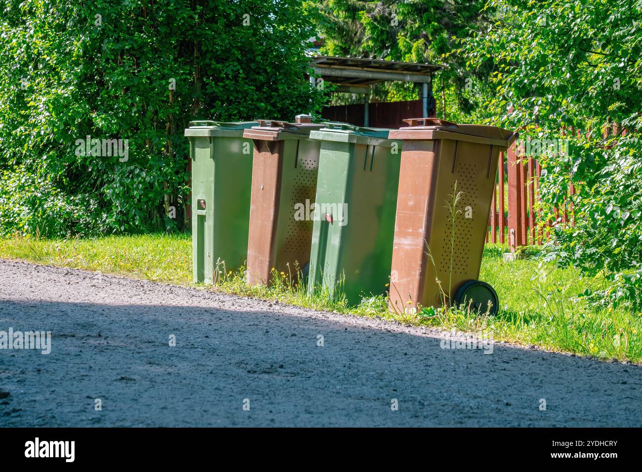 Four garbage bins are lined up and waiting to be emptied by the ...