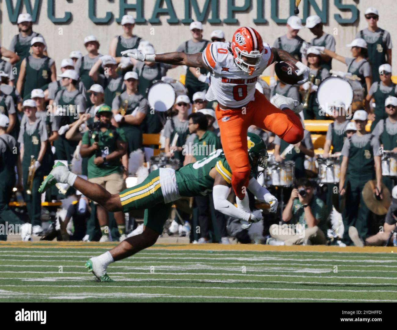 Oklahoma State running back Sesi Vailahi leaps over Baylor safety Devin ...